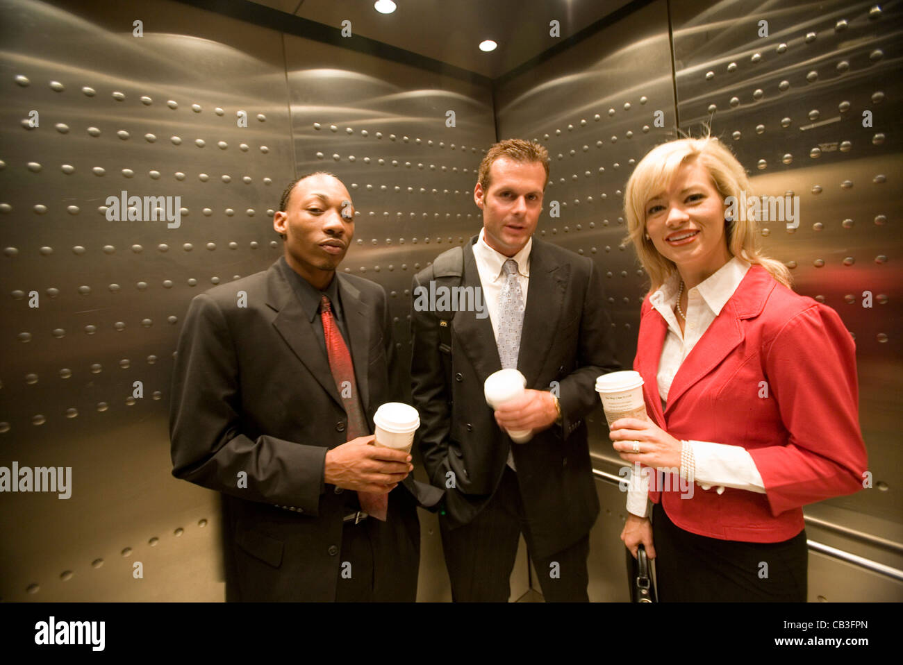 Portrait of business people riding in an elevator Stock Photo - Alamy