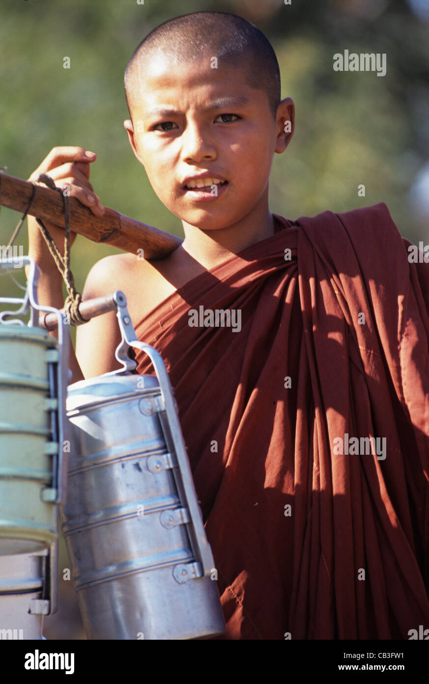 Young Buddhist Monk walking road with lunch boxes for alms, Magwe ...