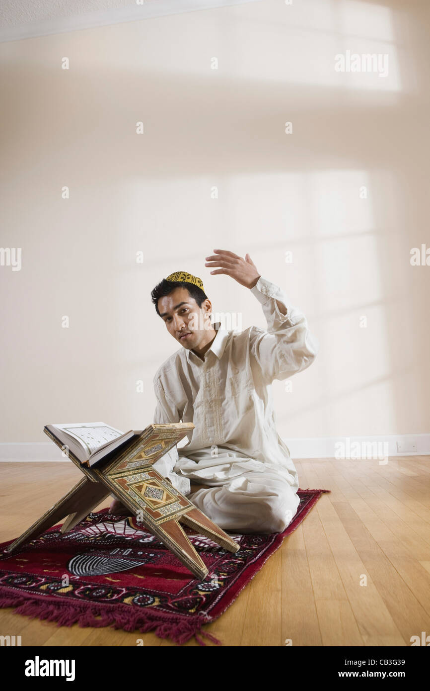 Portrait of a Muslim man sitting on a prayer mat Stock Photo - Alamy