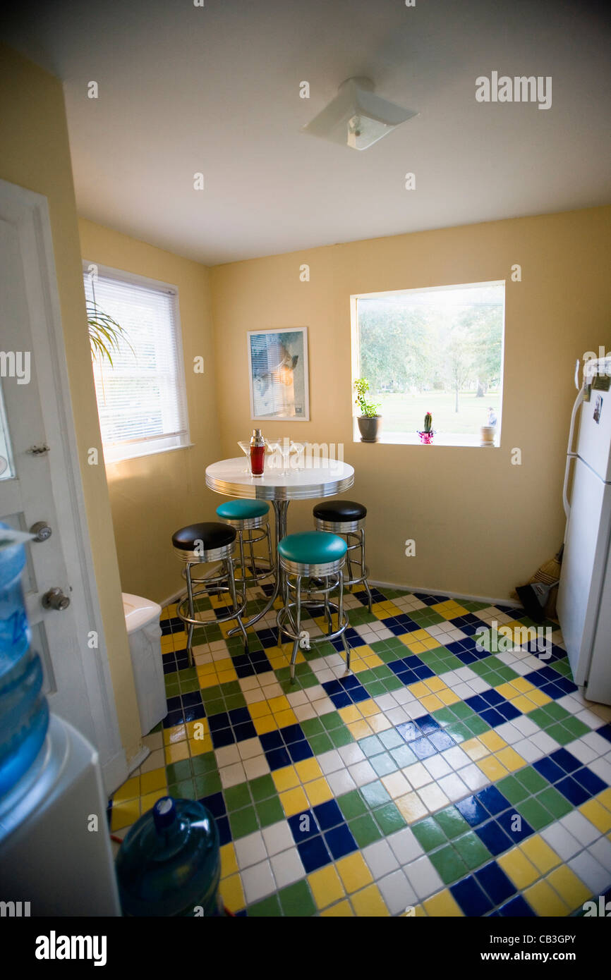 Table and stools arranged in empty kitchen Stock Photo - Alamy