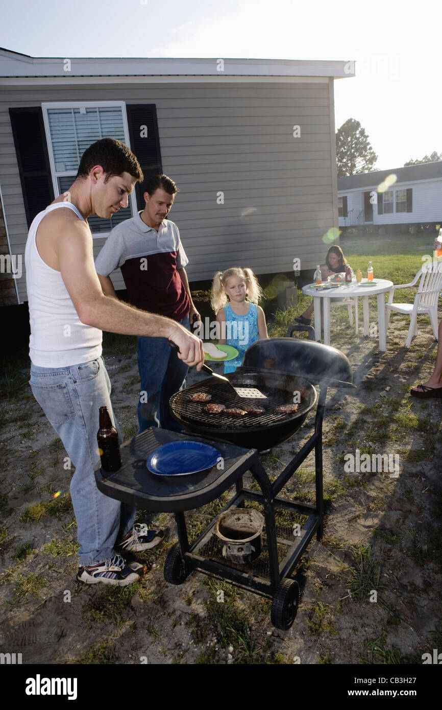 Blue collar families enjoying a cookout in front of trailer home Stock ...