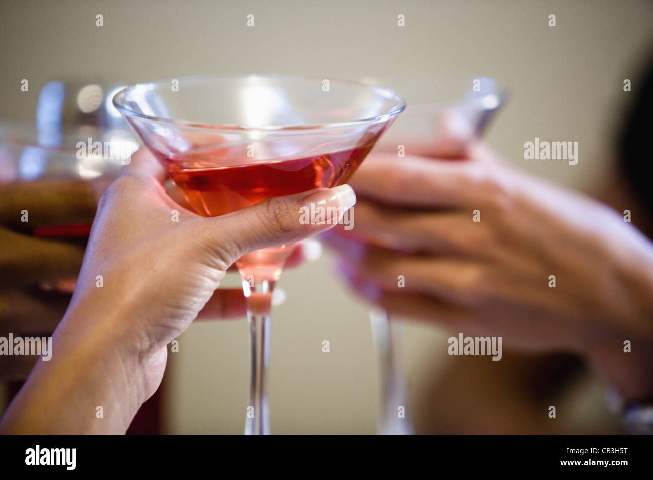 Three people raising glasses toast hi-res stock photography and images ...