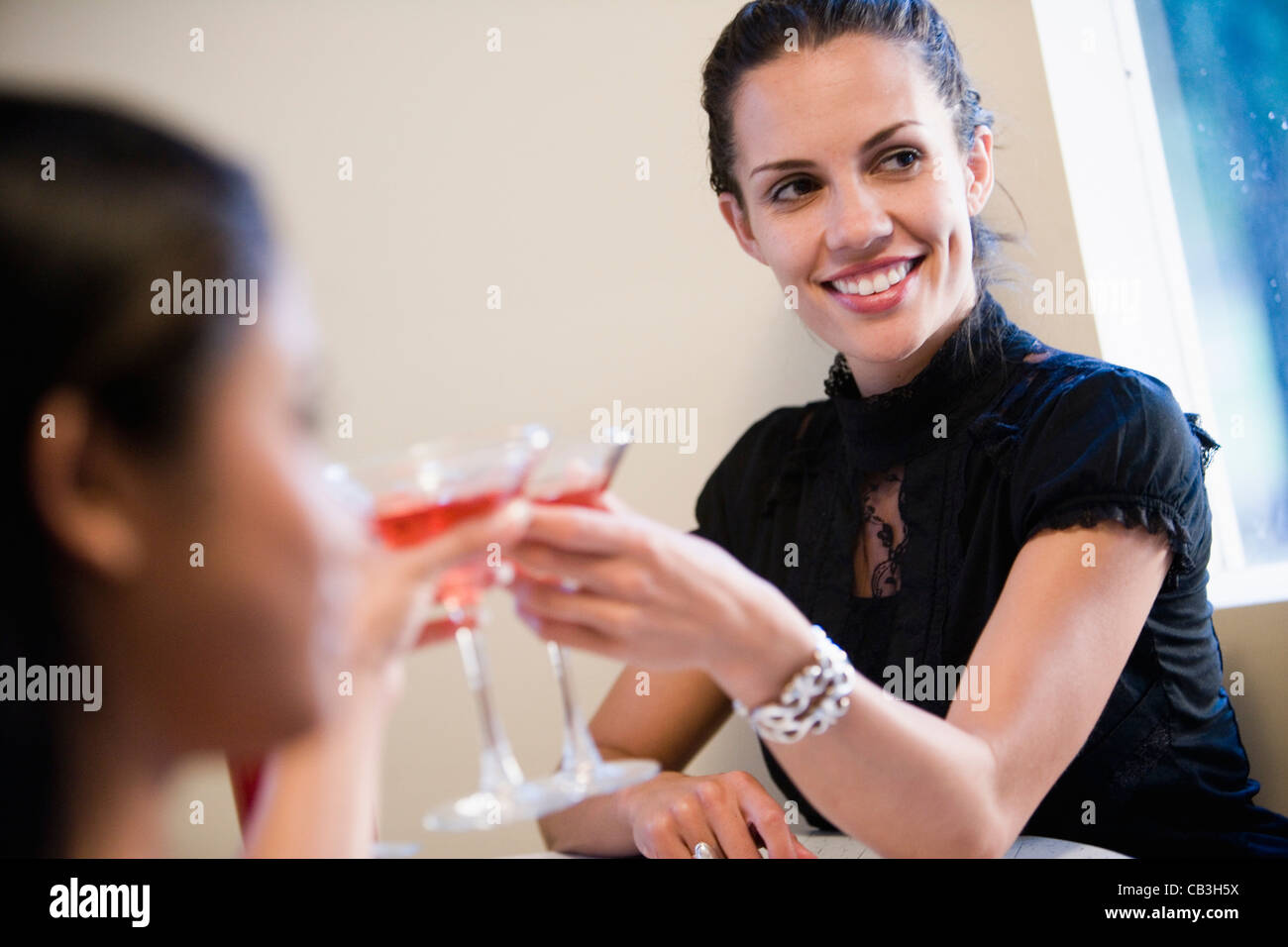 Woman toasting with a cocktail Stock Photo - Alamy