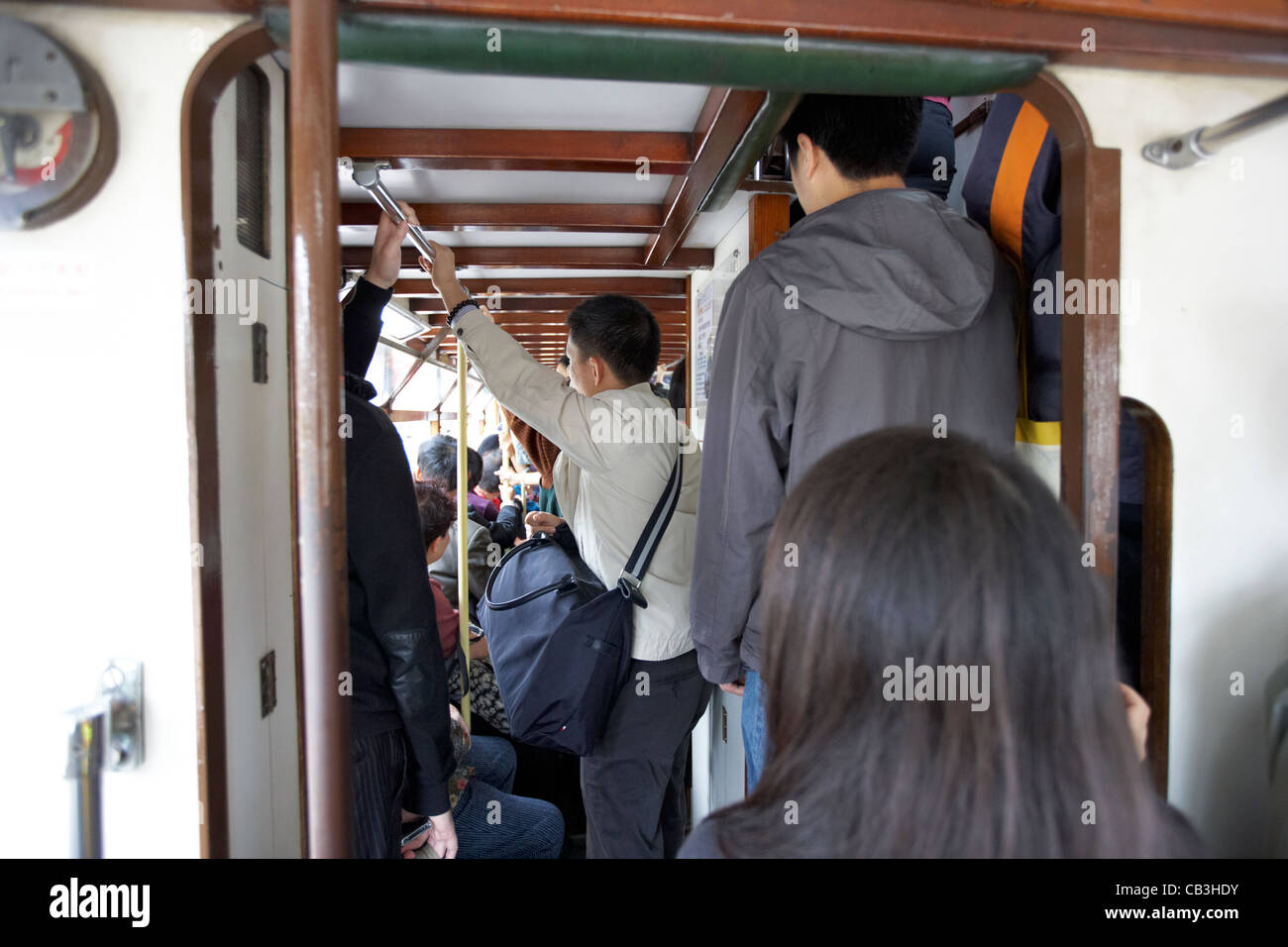 local chinese people on crowded old hong kong tram on hong kong island ...