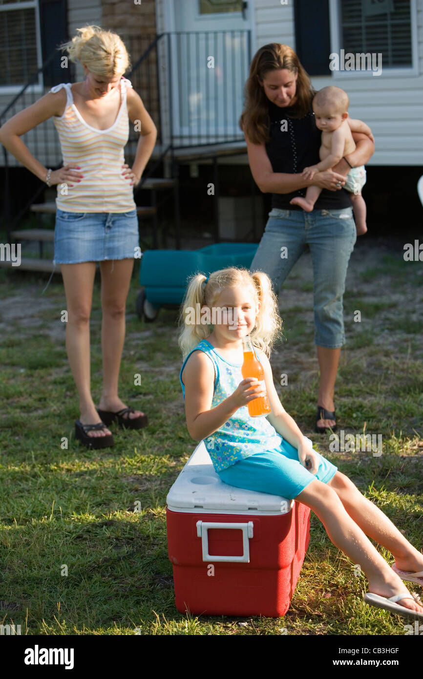 Young women and children in front of trailer home Stock Photo - Alamy