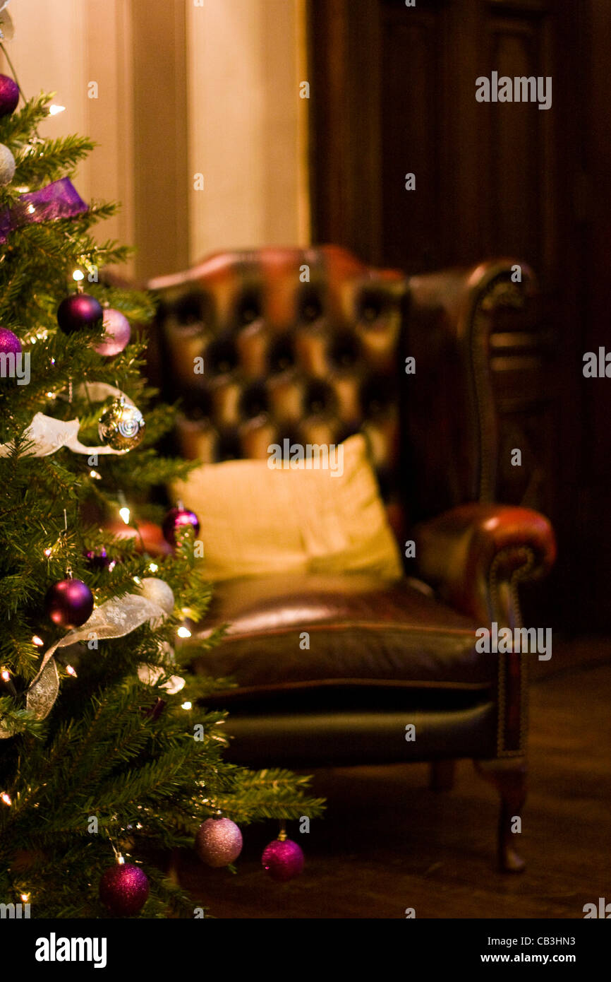 A Christmas scene with a Christmas Tree and Chair in view Stock Photo ...