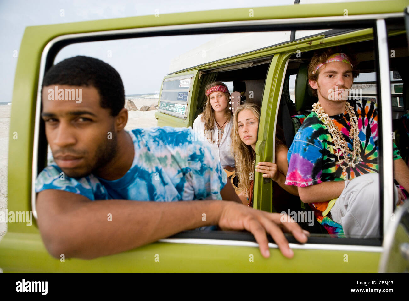 Portrait of hippies sitting in a van Stock Photo - Alamy