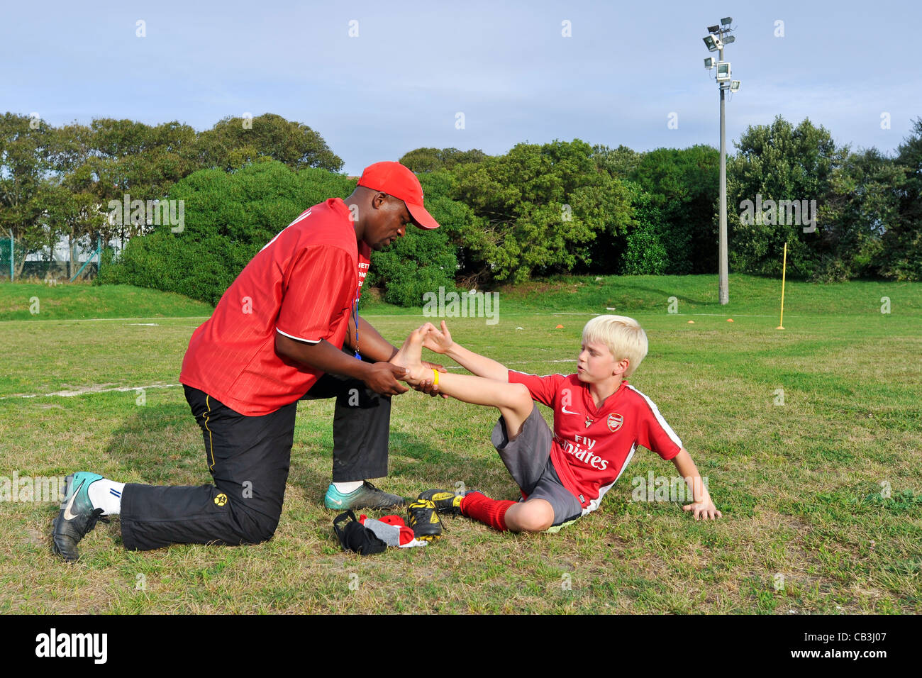 Football coach evaluates the injury of a youth team player Cape Town ...
