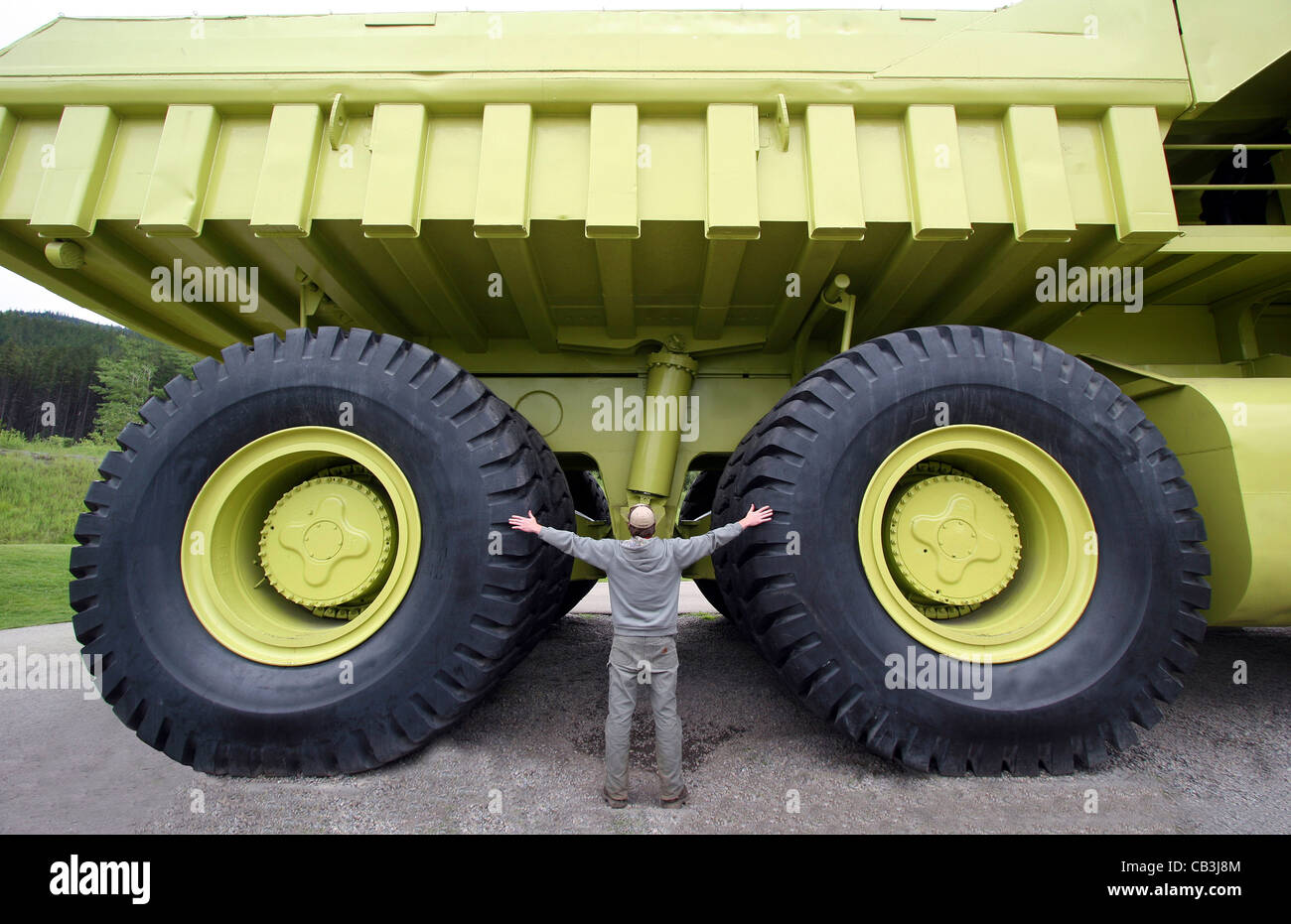 Rear view of a man standing near an earth mover Stock Photo - Alamy
