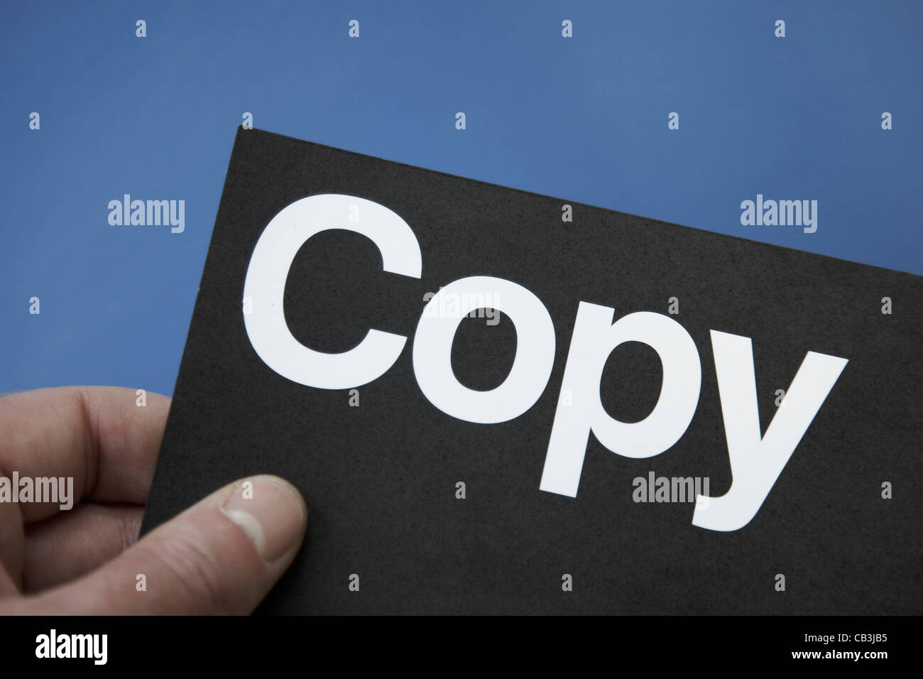 Hand holding card highlighting the word copy Stock Photo - Alamy