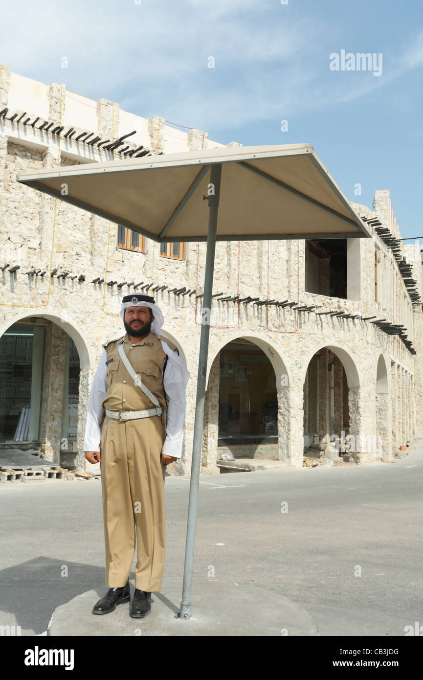 A tourist policeman in an old-fashioned uniform on traffic duty in Souq ...