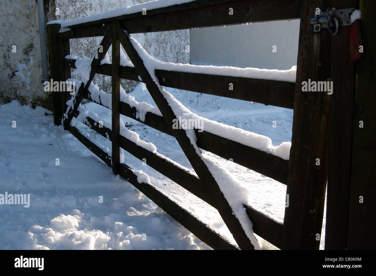 Snow covered farm gate landscape Stock Photo - Alamy
