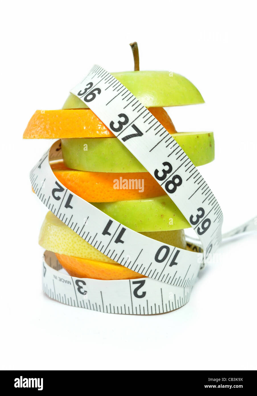 Tape measure wrapped around orange and apple slices Stock Photo - Alamy