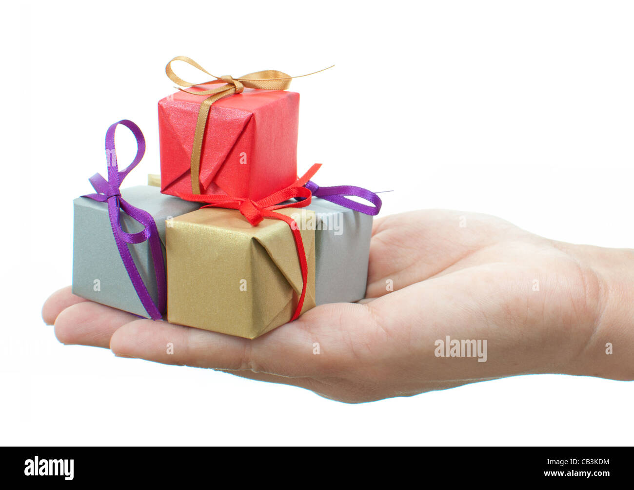 Hands presenting several colourful gift boxes Stock Photo - Alamy