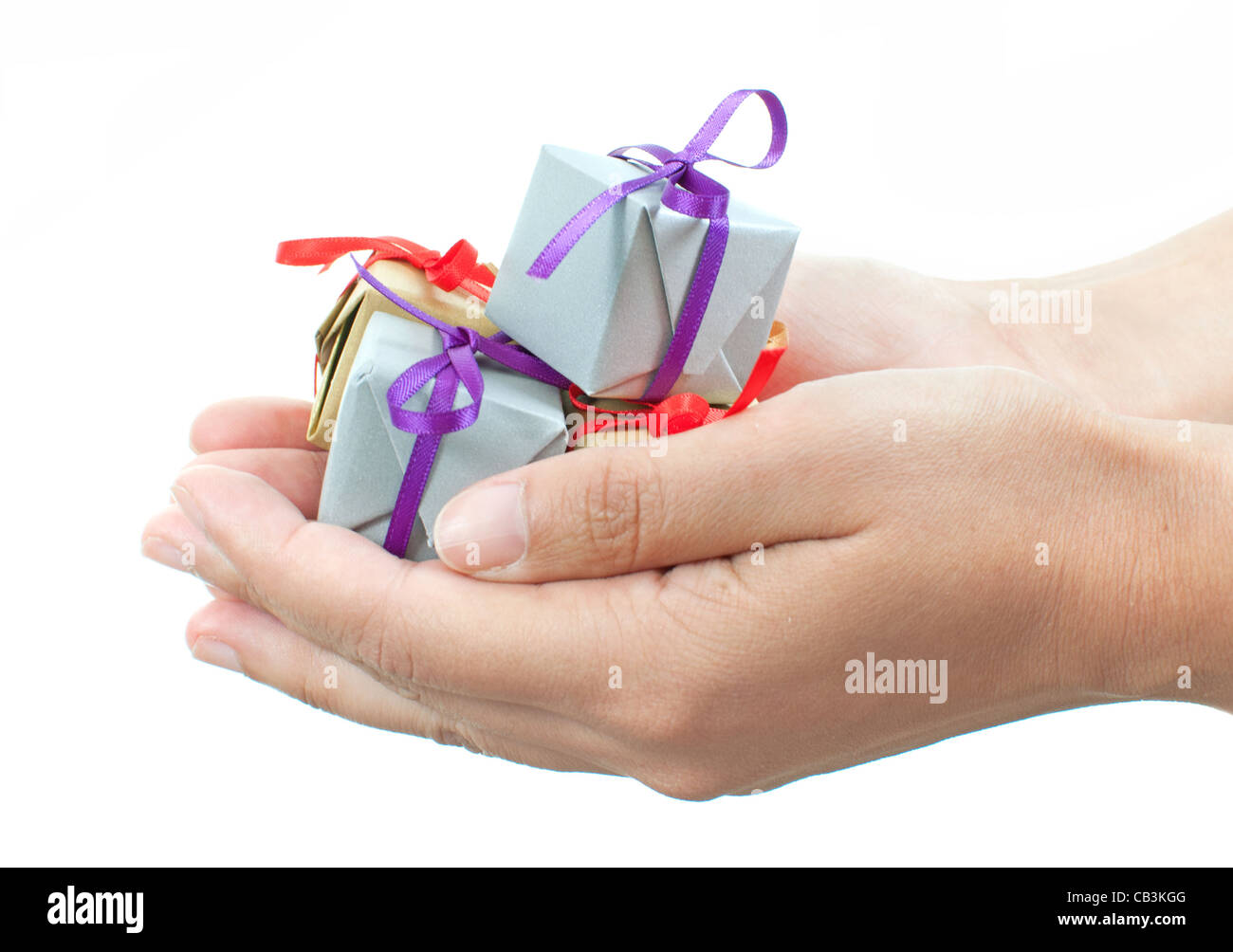 Hands presenting several small gift boxes Stock Photo - Alamy