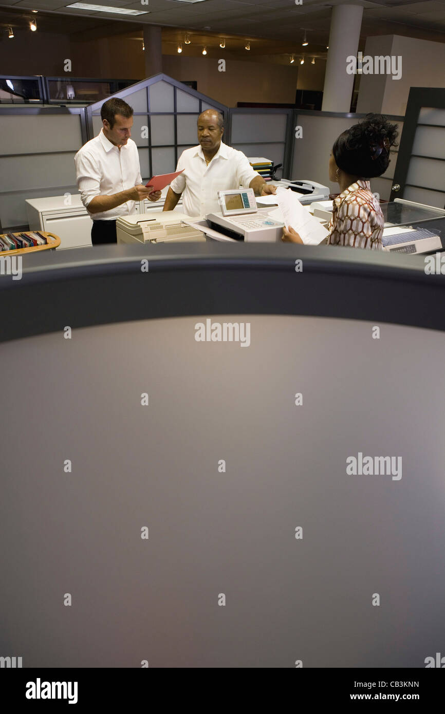 View of office worker at copy machine over cubicle wall Stock Photo - Alamy
