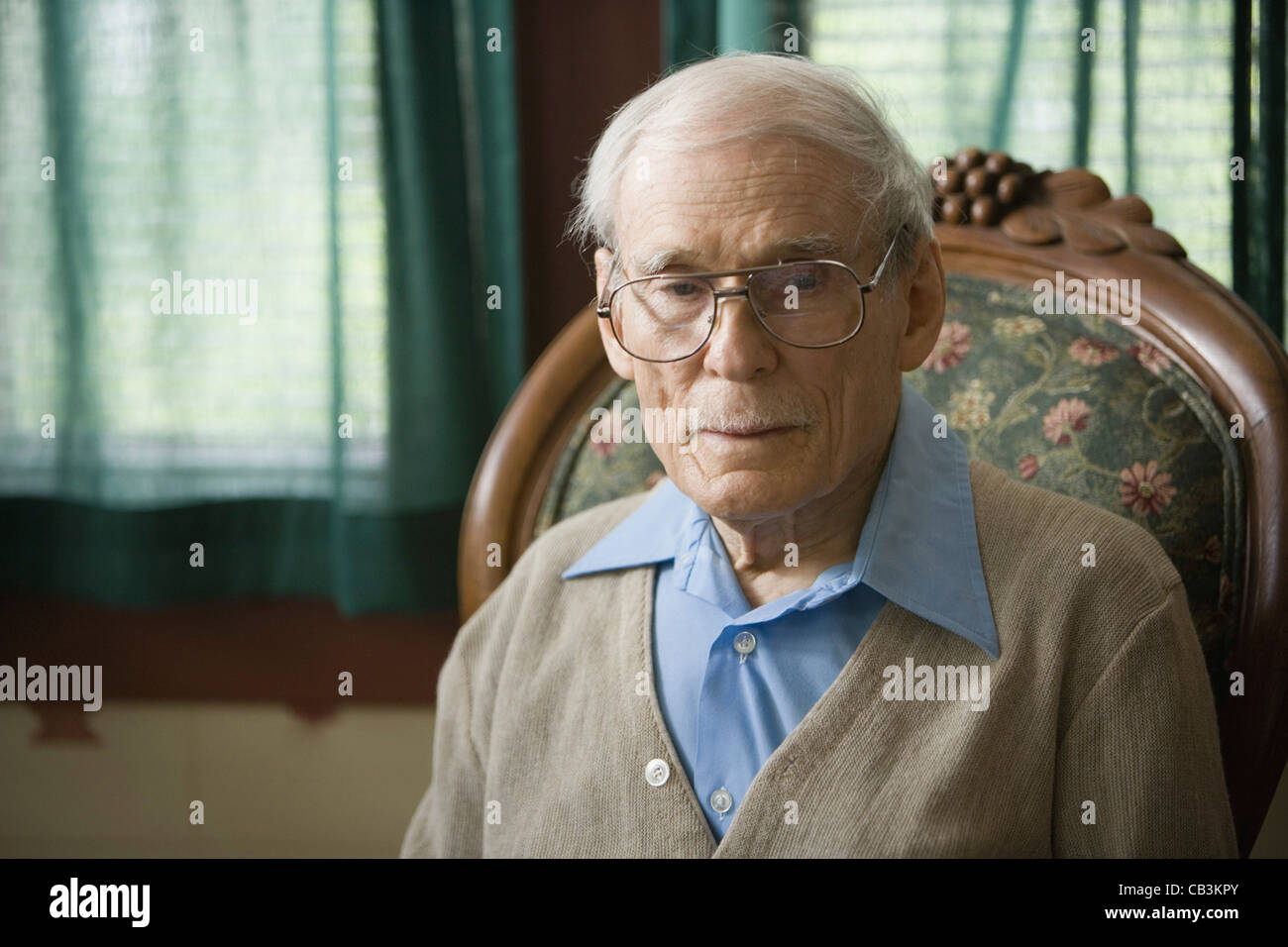 Older man on a chair hi-res stock photography and images - Alamy