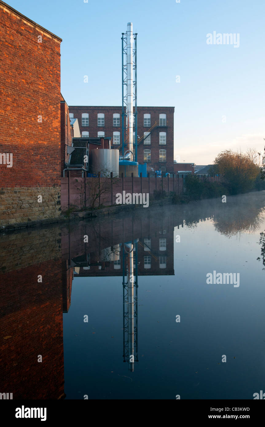 Chimney and factory reflected in canal hi-res stock photography and ...
