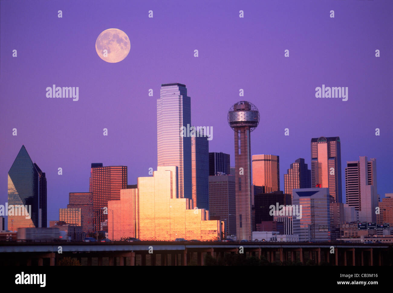 Dallas skyline glowing in sunset light under rising full moon Stock ...