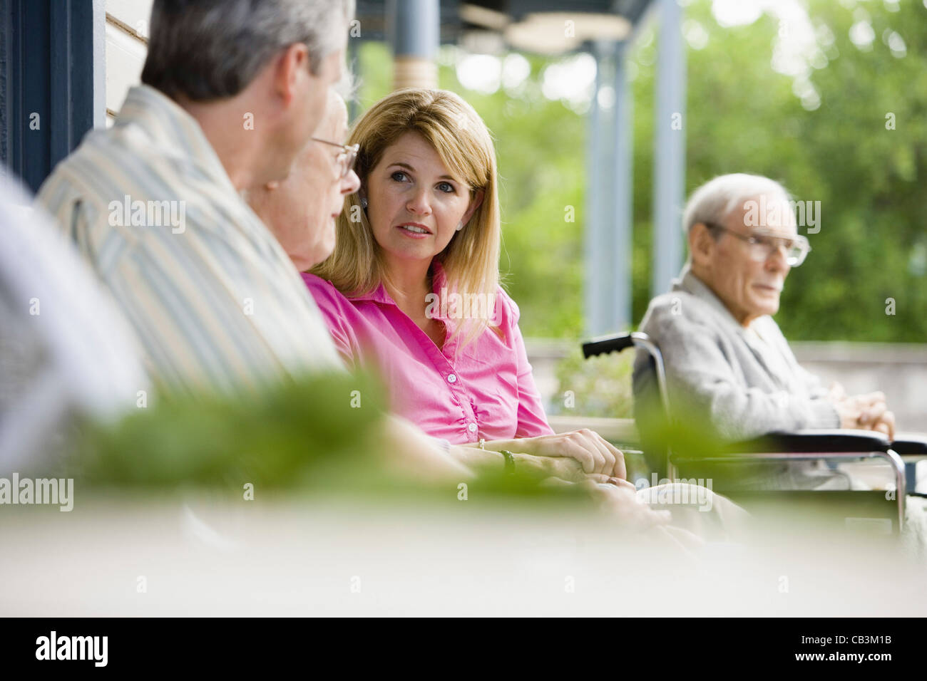 Adult children visiting with elderly parents Stock Photo - Alamy
