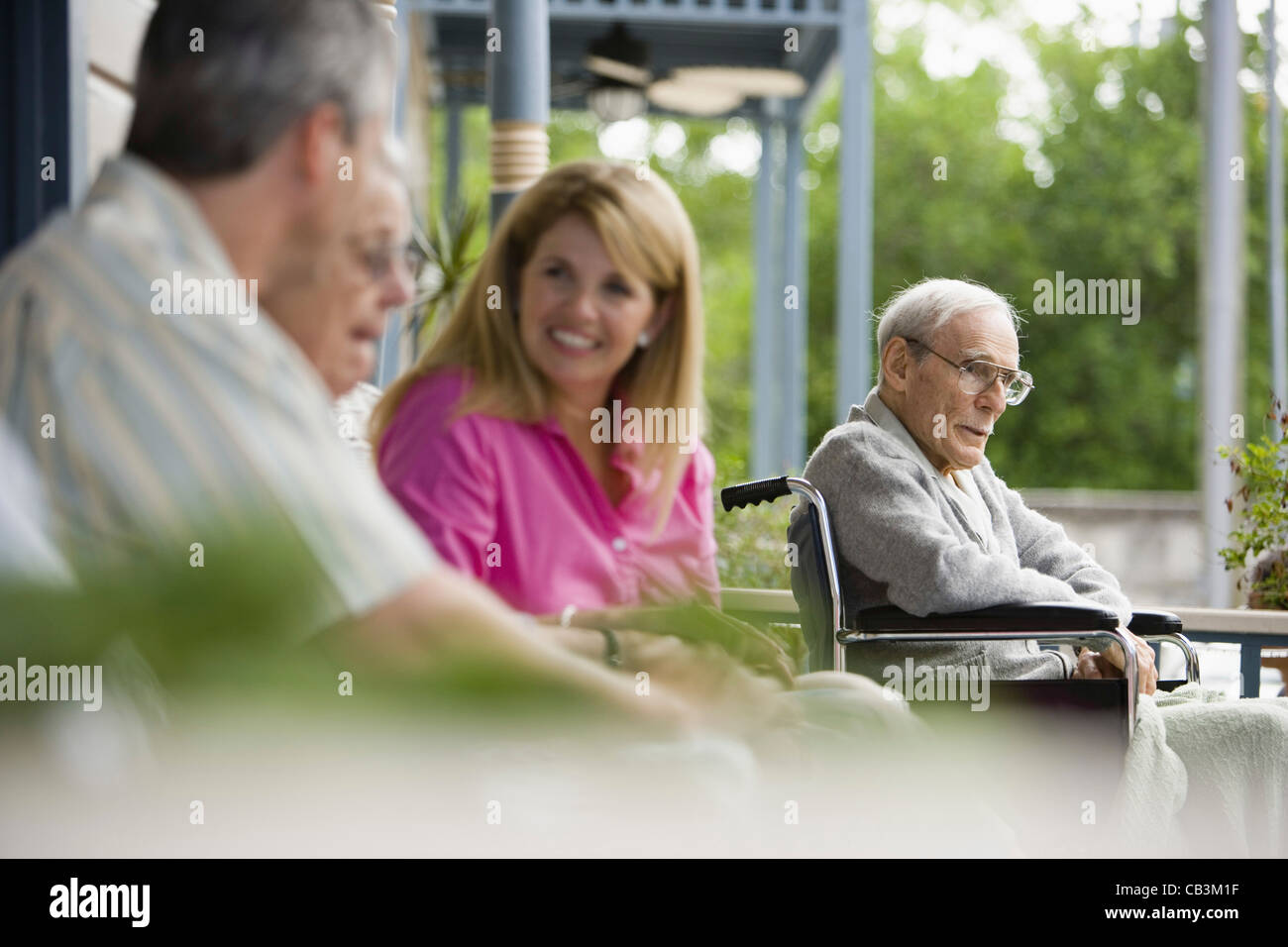 Adult children visiting with elderly parents Stock Photo - Alamy