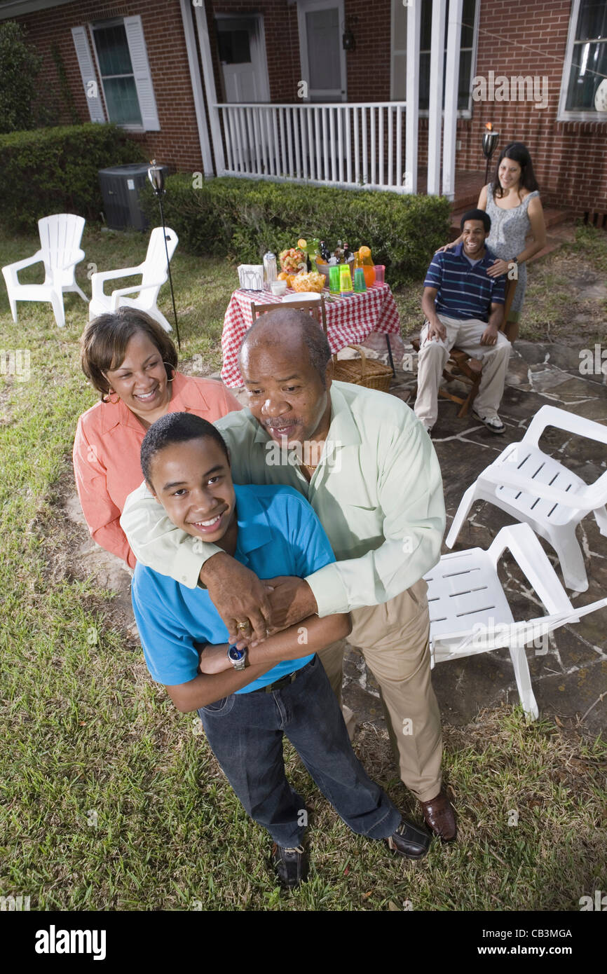 Family enjoying a backyard barbeque Stock Photo - Alamy