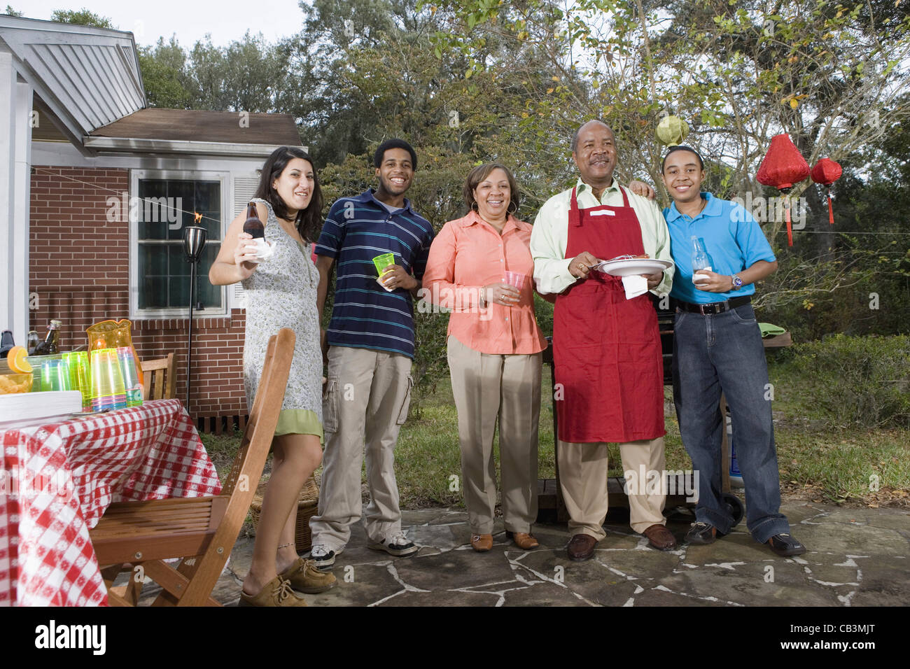 Family and friends enjoying backyard cookout Stock Photo - Alamy