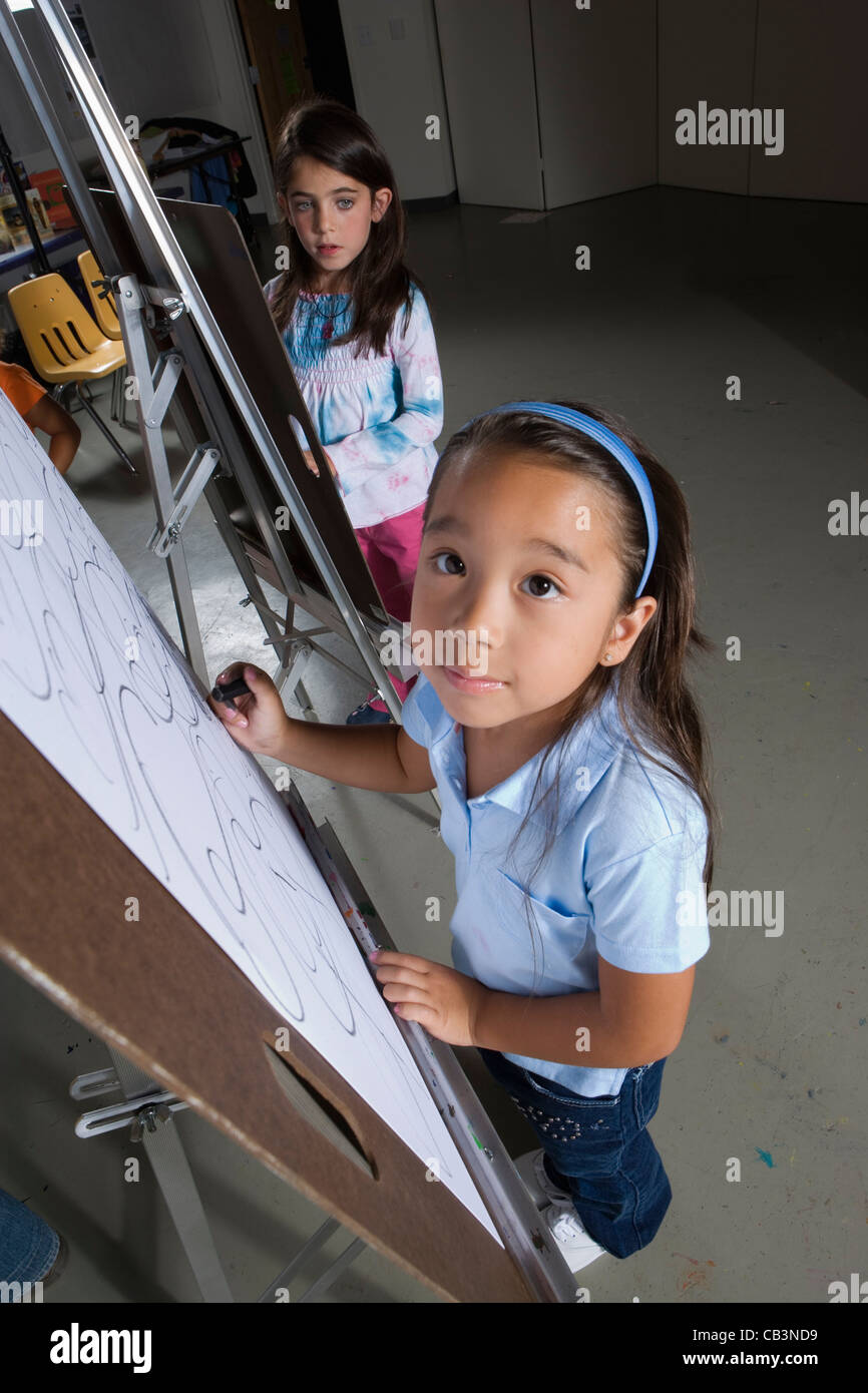 Portrait of girls drawing on easels in art class Stock Photo - Alamy