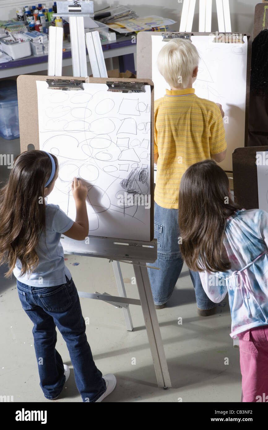 Young students drawing on easels in art class Stock Photo - Alamy
