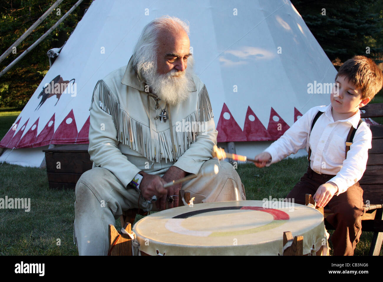 A Native American drummer with a little boy Stock Photo - Alamy