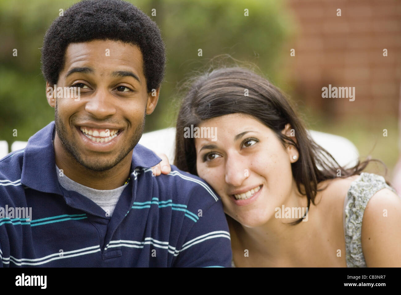 Smiling young inter-racial couple Stock Photo - Alamy