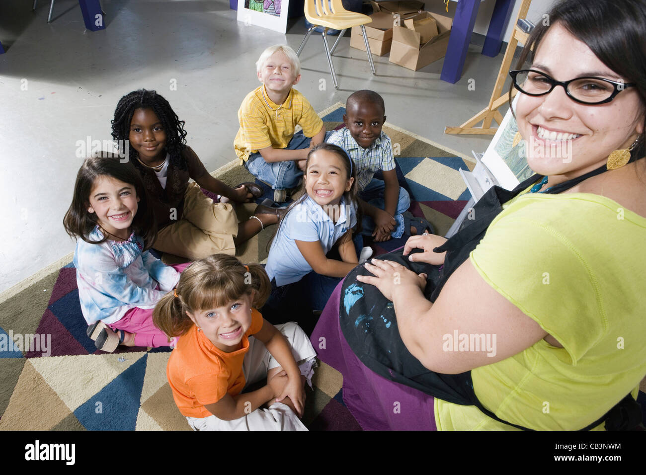 Portrait of an art teacher posing with her students Stock Photo - Alamy