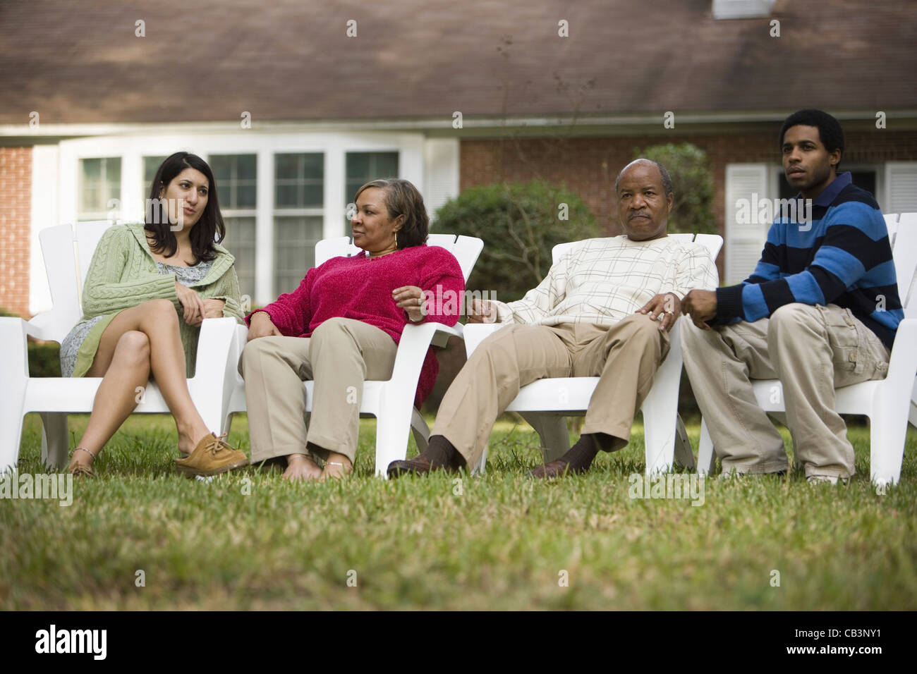 Family sitting on lawn chairs hi-res stock photography and images - Alamy
