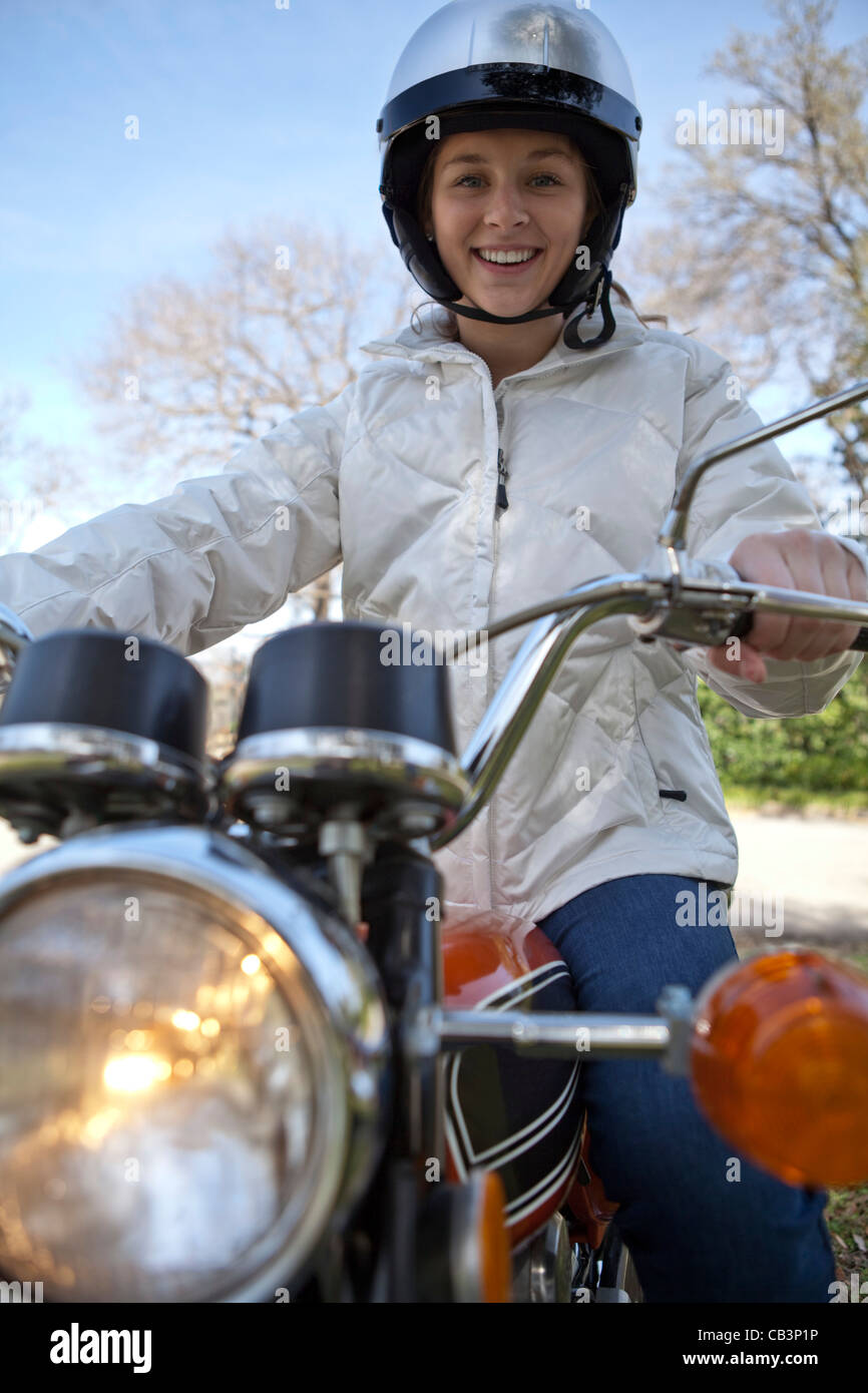 Portrait of smiling teenage girl sitting on motorcycle Stock Photo - Alamy