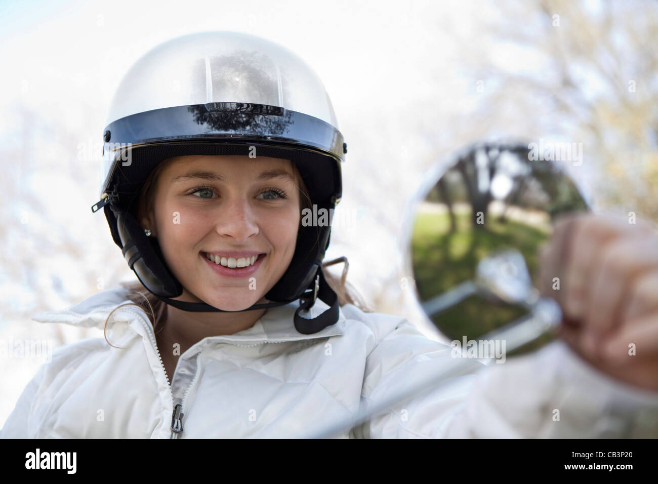 Smiling teenage girl sitting on motorcycle Stock Photo - Alamy