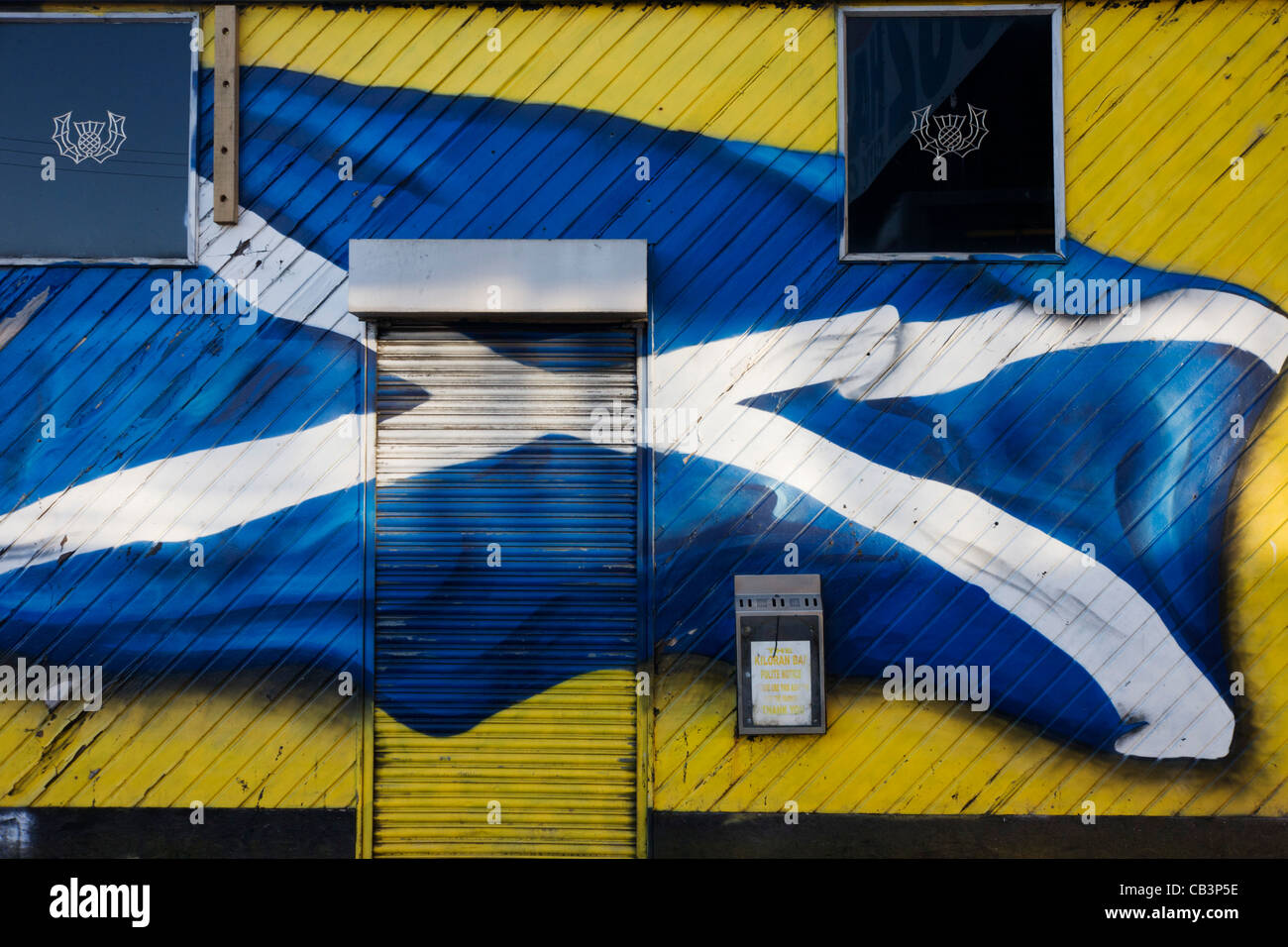 A sprayed Cross of St Andrew flag of Scotland flies across the wall and ...