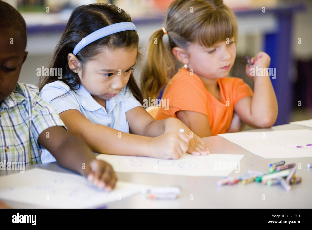 Girls drawing with crayons in an art class Stock Photo - Alamy