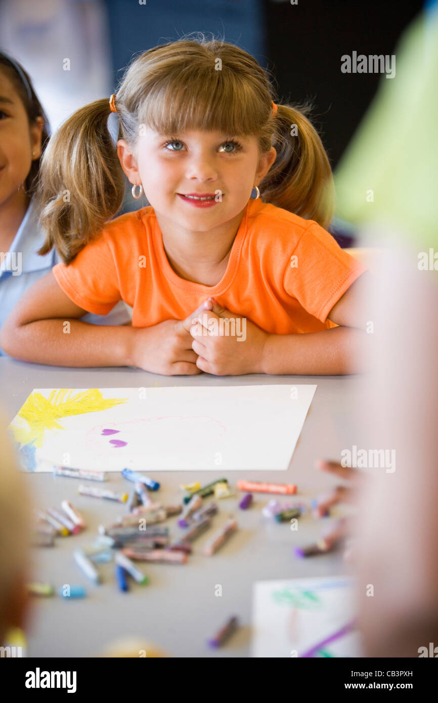Close up of little girl looking up at teacher in class Stock Photo - Alamy