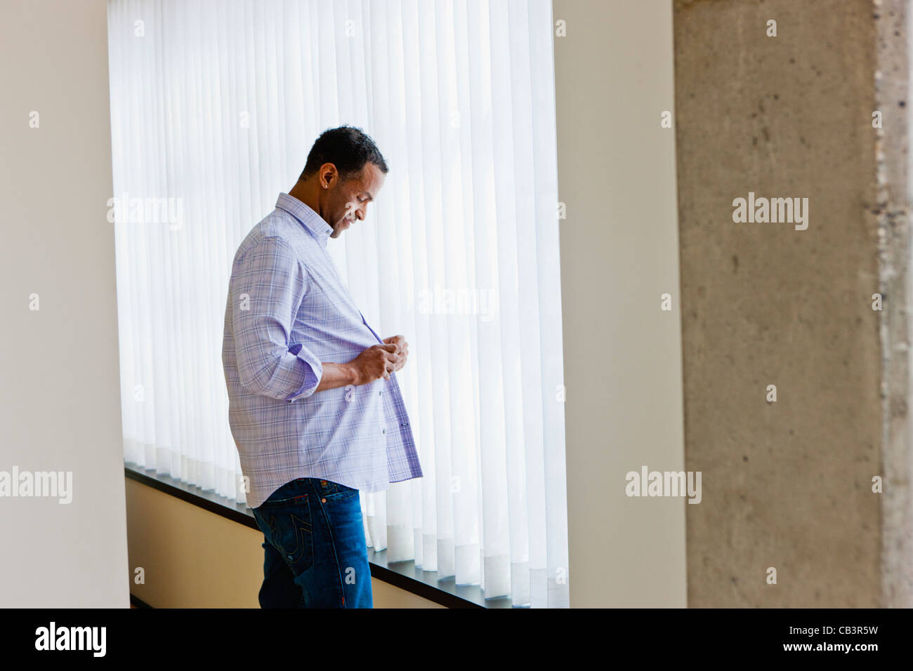 Man getting dressed Stock Photo - Alamy
