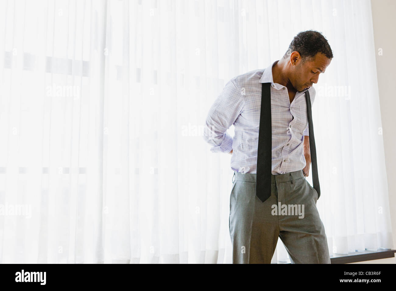 Man getting dressed Stock Photo - Alamy