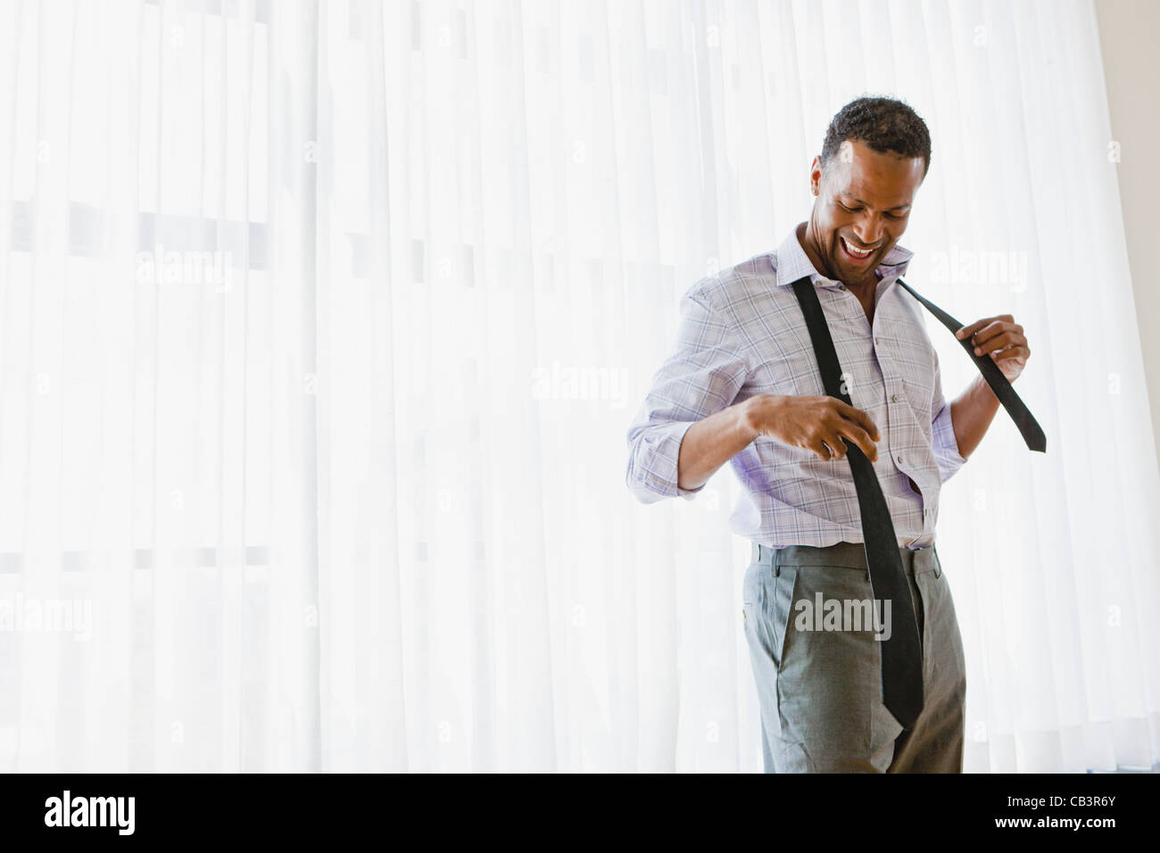 Man getting dressed Stock Photo - Alamy