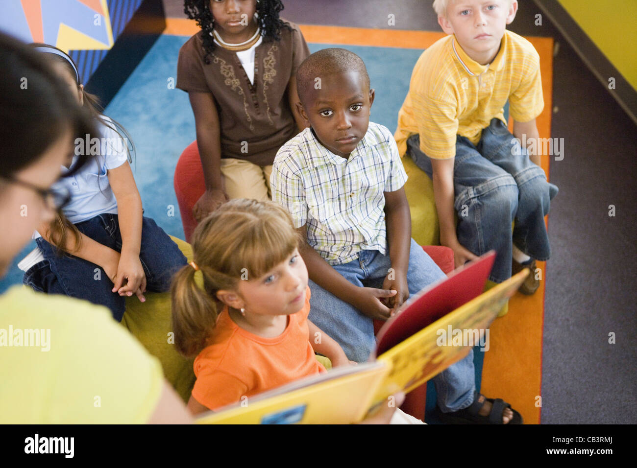 Students sitting in classroom, watching and listening attentively to ...