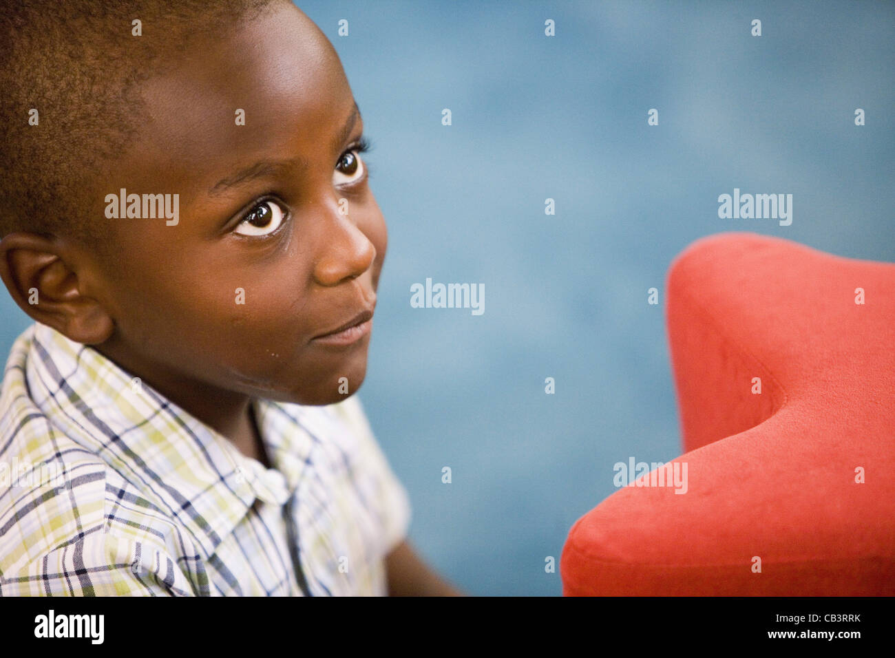 Head-shot of a young boy in a colorful room Stock Photo - Alamy