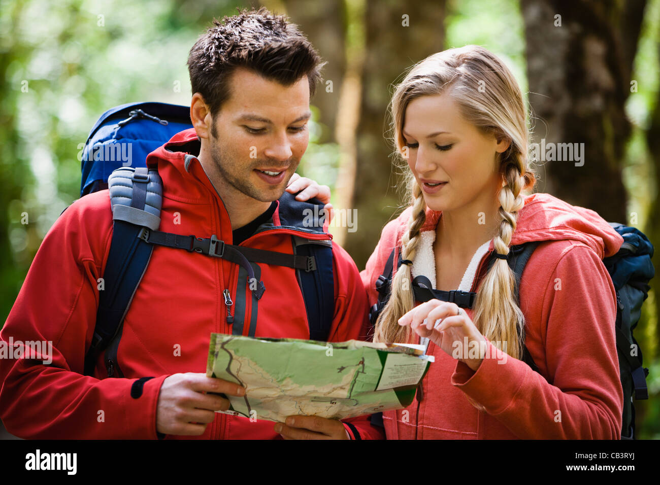 Two young men reading map forest hi-res stock photography and images ...