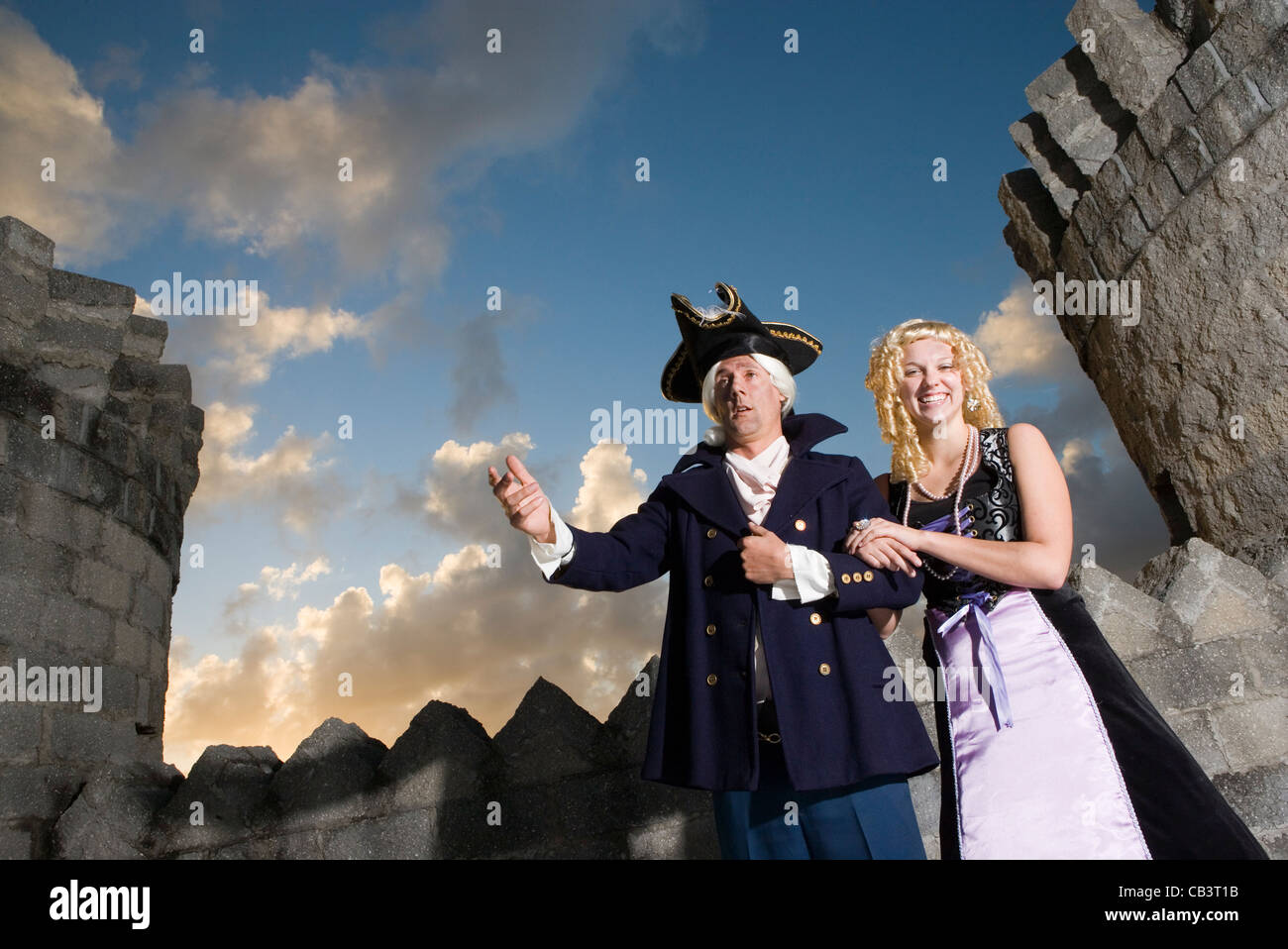 View of a navy officer and a princess with castle turrets and parapets ...