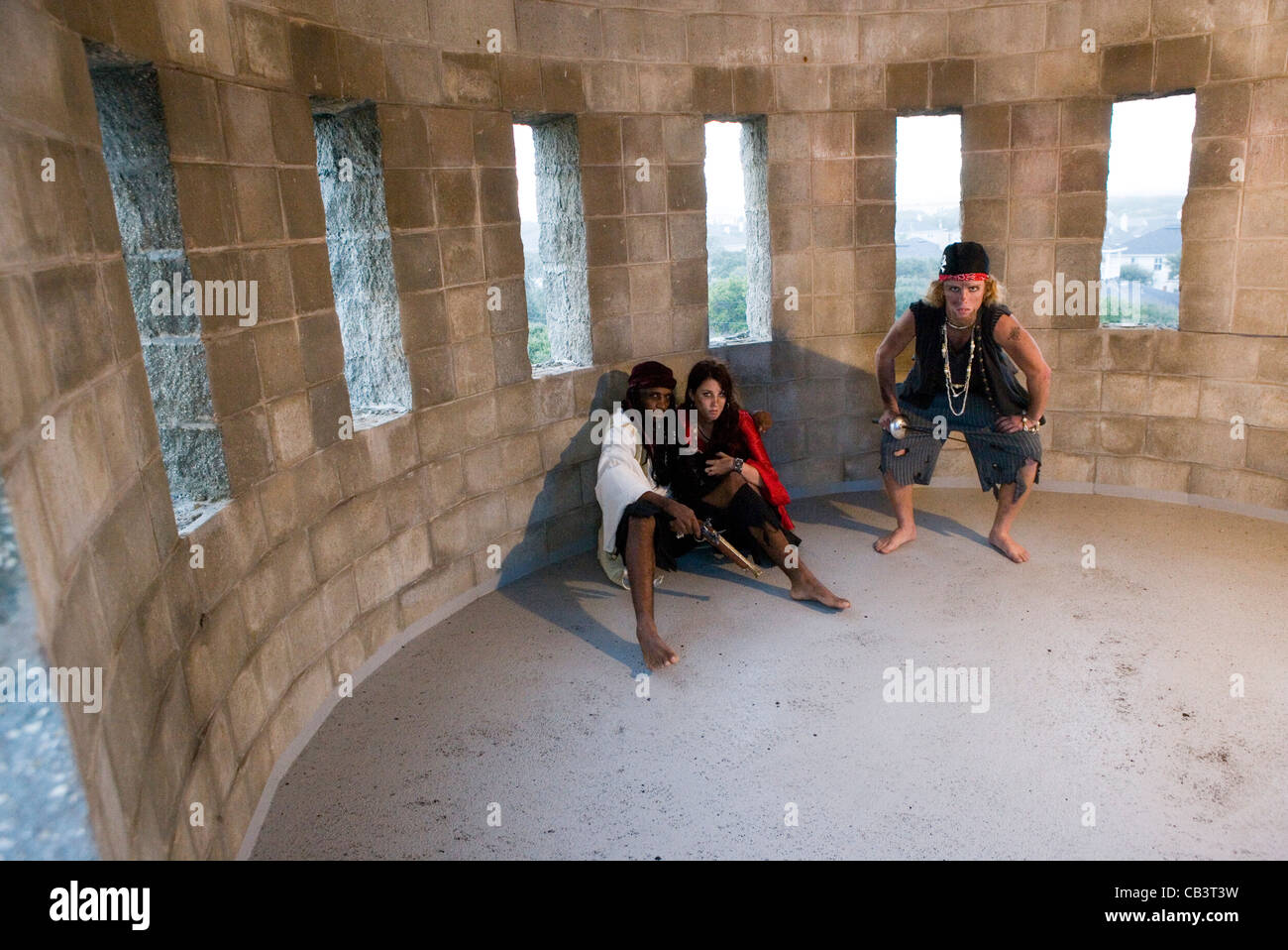 Pirates sitting on the ground inside a castle turret Stock Photo - Alamy