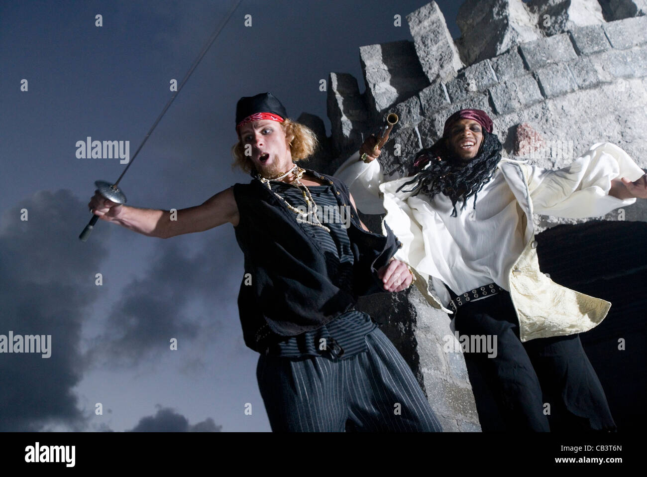 Low angle view of pirates brandishing a sword and a gun Stock Photo - Alamy