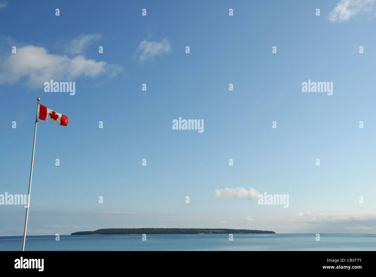 Canadian flag and Griffith island seen from Big Bay pebble beach of ...