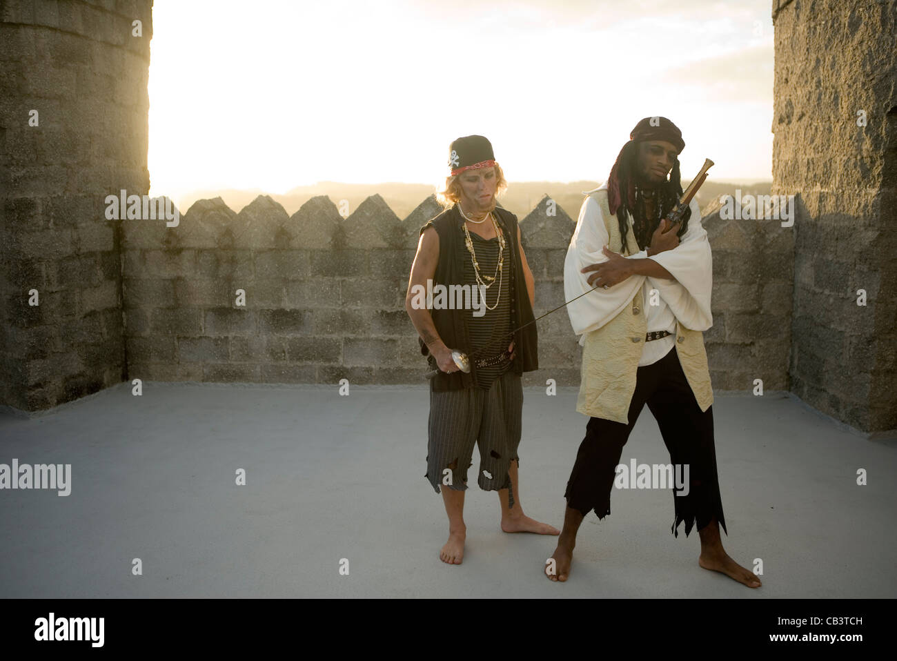 Armed pirates with castle parapets and turrets in the background Stock ...