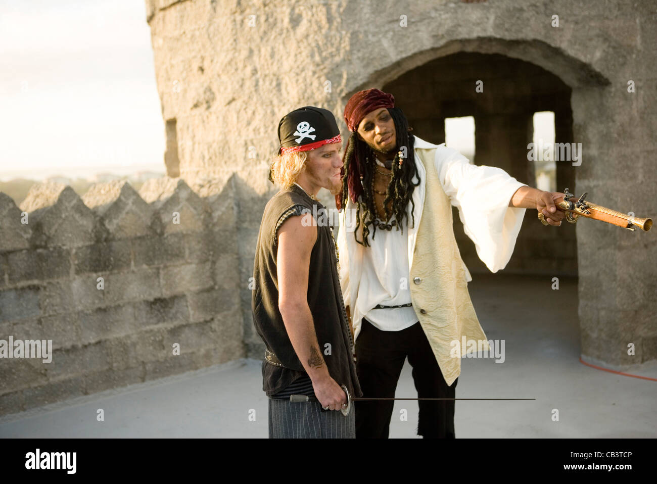 Armed pirates with castle parapets and turrets in the background Stock ...